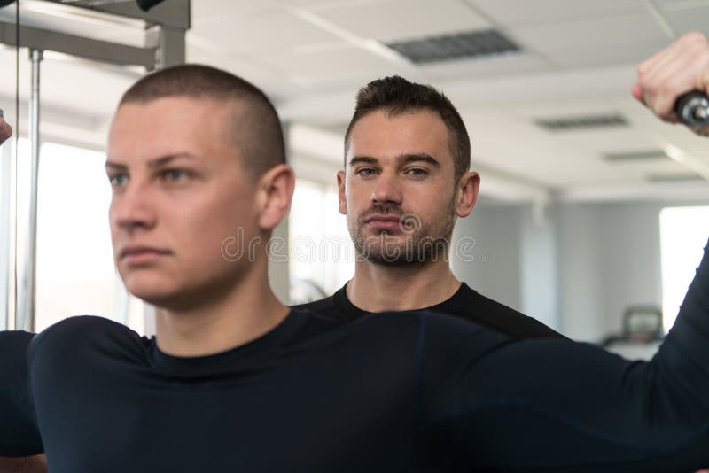 Personal Trainer Helping Client in Gym Stock Image - Image of muscle ...