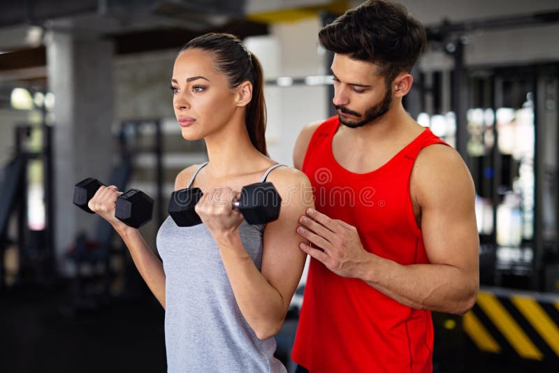 Personal Trainer Helping Woman To Working Out In Gym Healthy Lifestyle