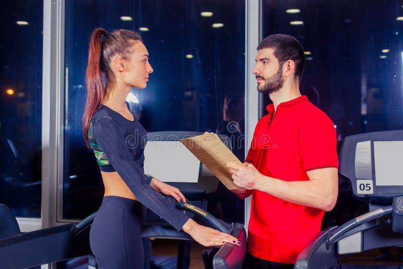 Personal Trainer Helping Woman Working with Treadmill Stock Photo ...