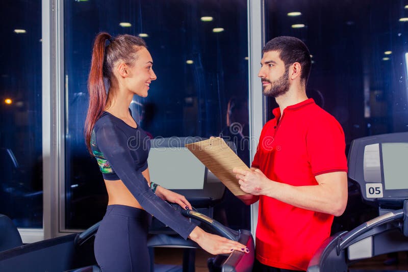 Personal Trainer Helping Woman Working with Treadmill Stock Image ...