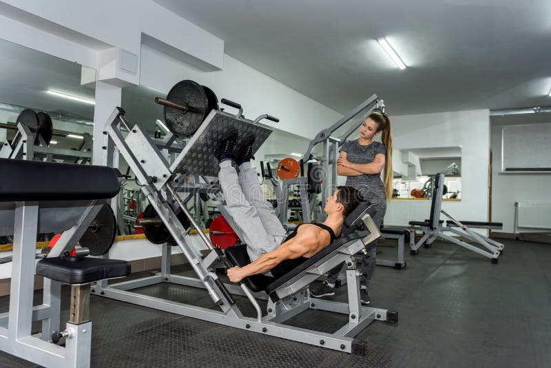 Personal Trainer Helping Work with Barbell in Gym Stock Image - Image ...