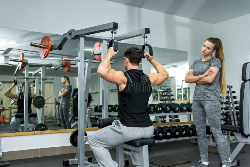 Personal Trainer Helping Work with Barbell in Gym Stock Image - Image ...