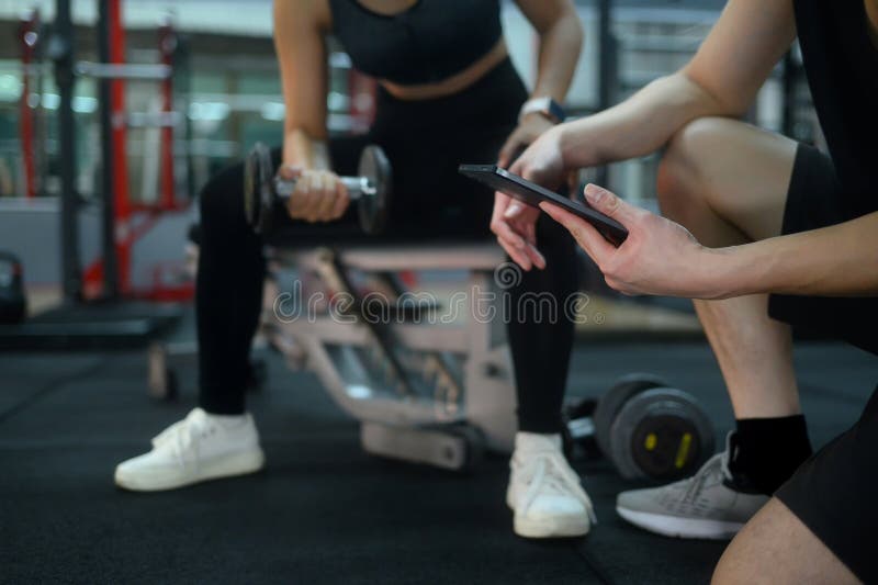 Personal Trainer Holding Digital Tablet To Assess Client Performance ...