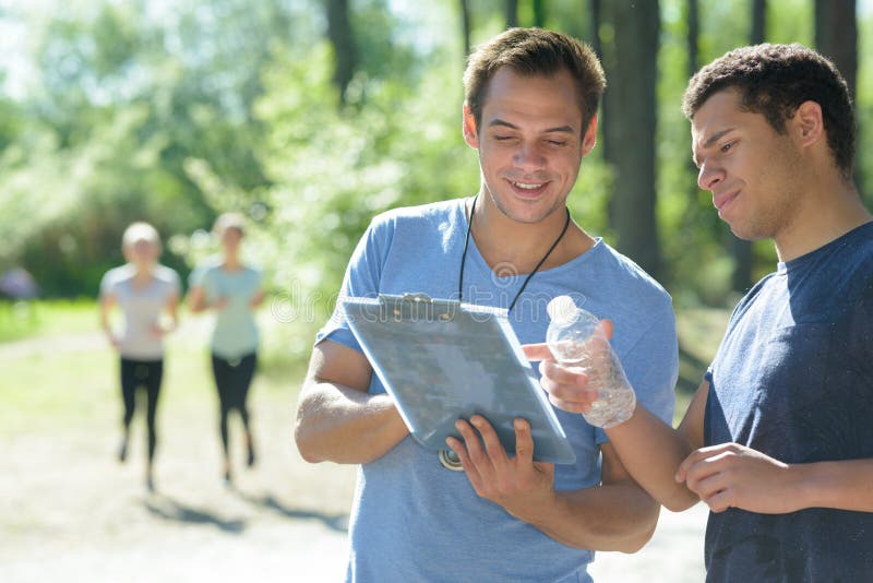 Personal Trainer Takes Notes after Exercising Outdoors Stock Photo ...