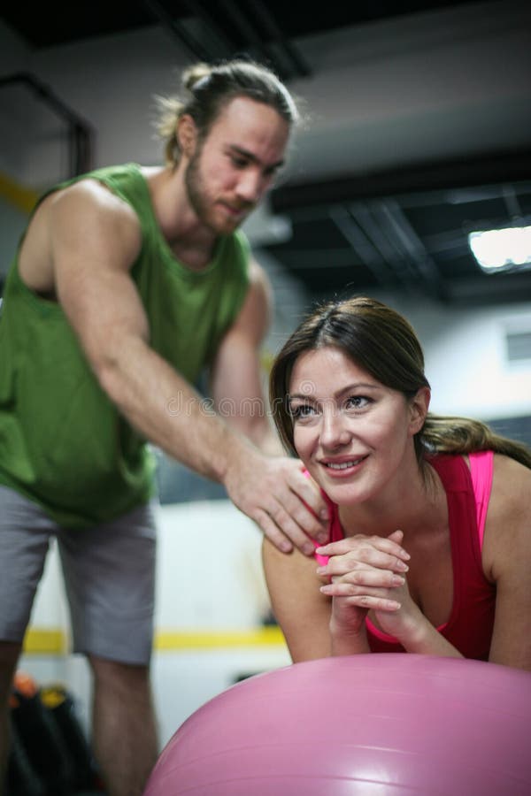 Personal Trainer Training His Client in the Gym. Stock Photo - Image of ...