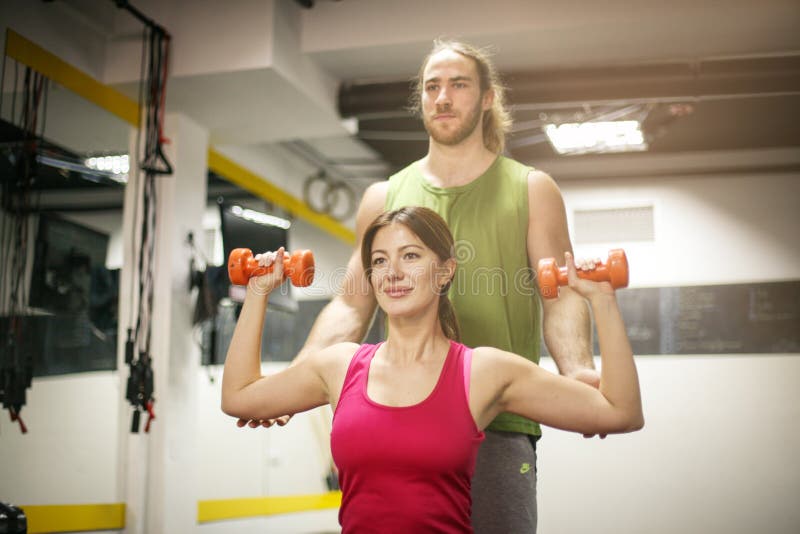 Personal Trainer Training His Client in the Gym. Stock Image - Image of ...