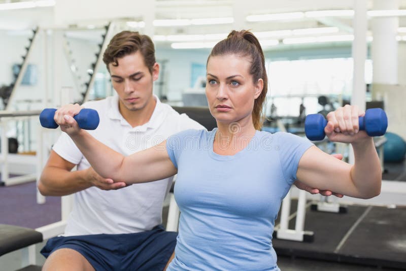 Personal Trainer Working with Client on Exercise Ball Stock Photo ...