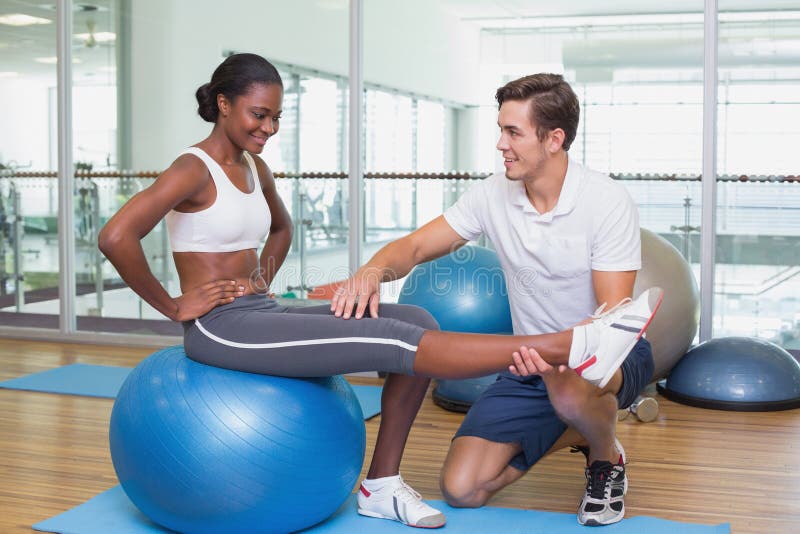 Personal Trainer Working with Client on Exercise Ball Stock Image ...
