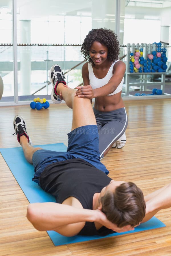 Personal Trainer Working with Client on Exercise Mat Stock Image ...