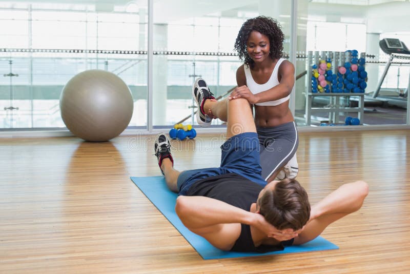 Personal Trainer Working with Client on Exercise Mat Stock Photo ...