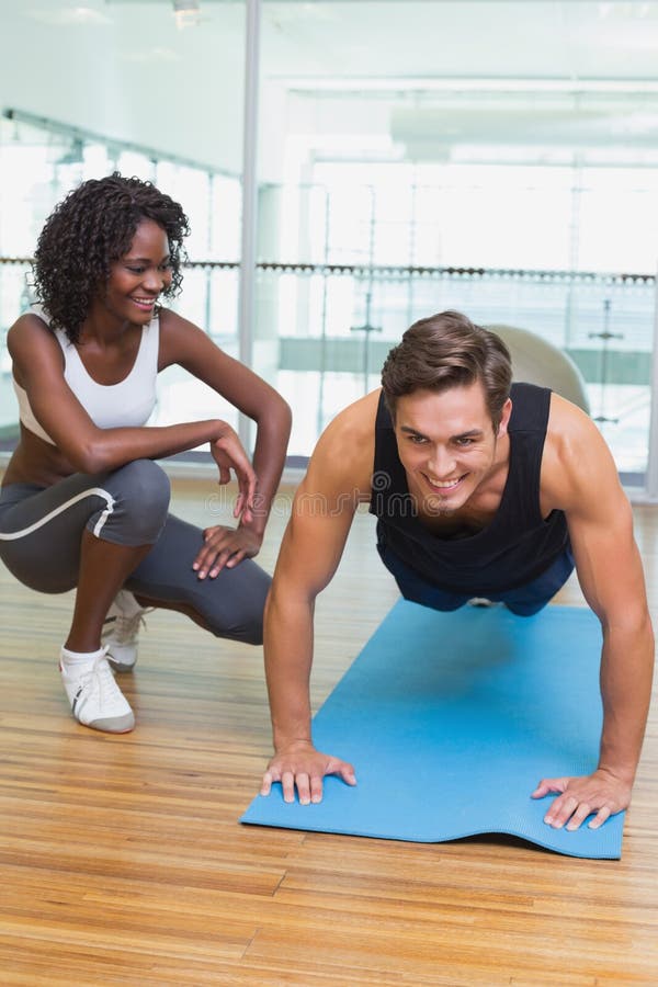 Personal Trainer Working with Client on Exercise Mat Stock Image ...