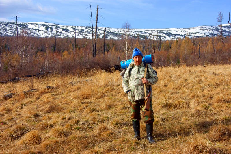 Persons with Handgun on Background of the Mountains Stock Photo - Image ...