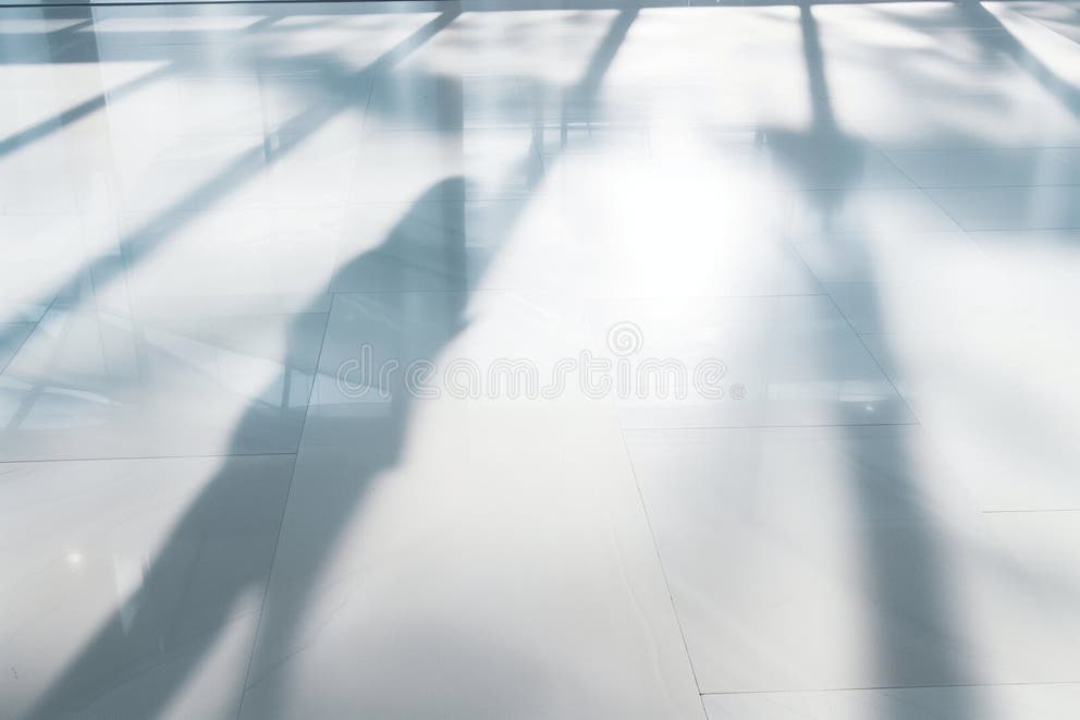 Persons Shadow Cast Dramatically on a Pristine, White Backlit Floor ...