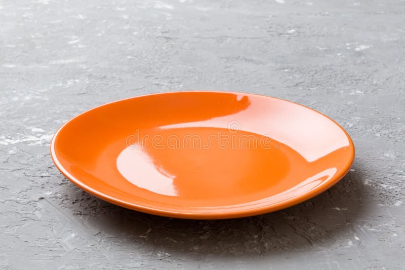 Perspective View of Empty Orange Plate on Cement Background. Empty ...