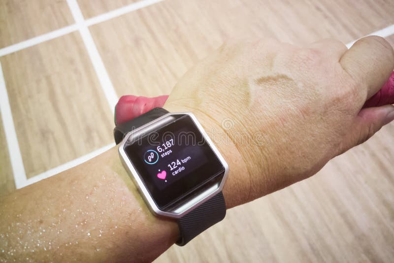 Perspective View Person Reading Watch with Steps and Heart Tracker ...