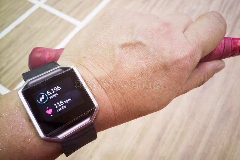 Perspective View Person Reading Watch with Steps and Heart Tracker ...