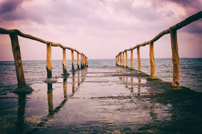 Perspective View of a Pier on the Seashore with Clear Blue Sea and ...