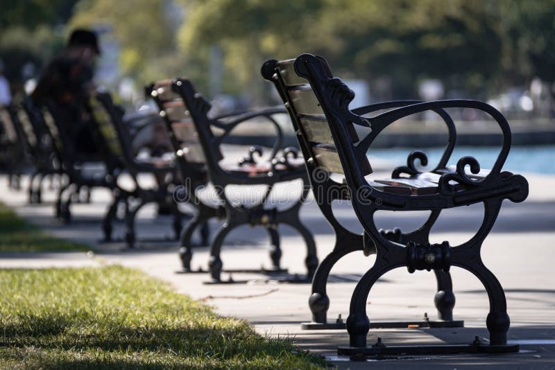 Perspective View of a Row of Bench by the Sea, a Young Man Sitting in ...