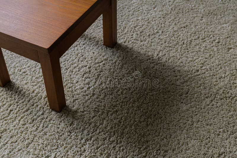 Perspective View of Small Teak Table on Beige Carpet. Stock Photo ...
