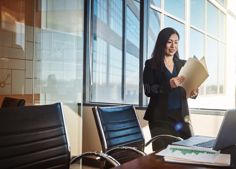 Perusing the Paperwork. a Mature Businesswoman Looking Over Some ...