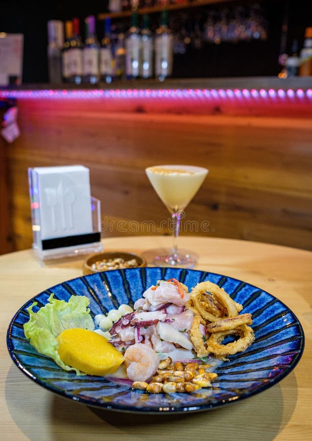 Peruvian Ceviche Served on a Blue Plate, Accompanied by Pisco and ...