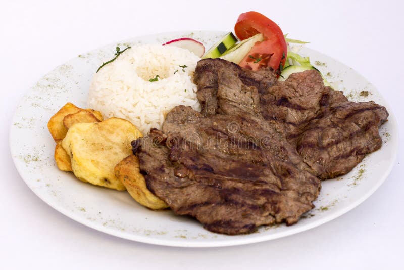 Peruvian Dish: Beef Grilled with Rice, Potatoes and Salad Stock Photo ...