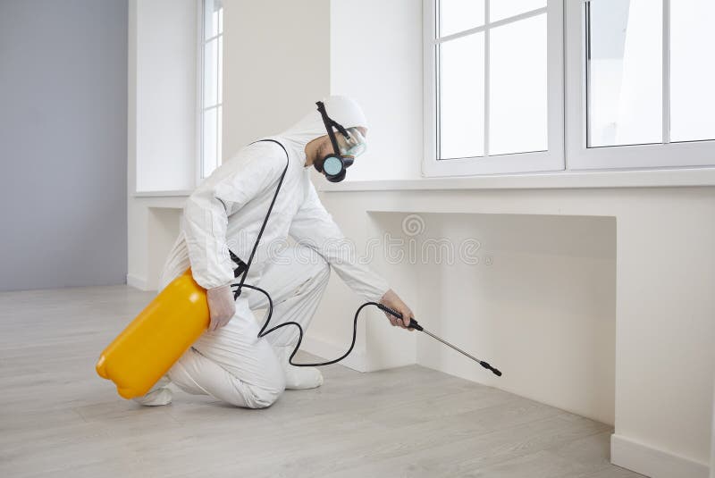 Pest Control Exterminator in Protective Mask and Suit Spraying ...