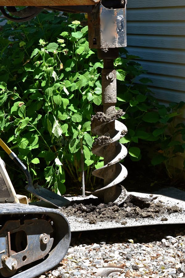 An Auger Digs Hole for a Deck Post. Stock Photo - Image of rocks ...