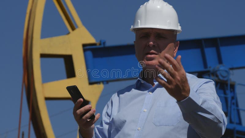 Petroleum Engineer Working in Extracting Oil Industry Talking with Cell ...