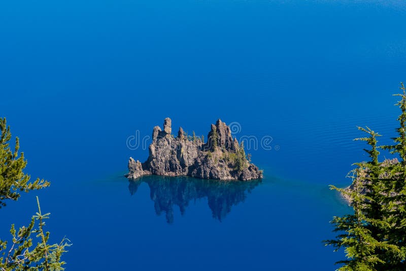 Phantom Ship Rock through the Trees of Crater Lake Stock Image - Image ...