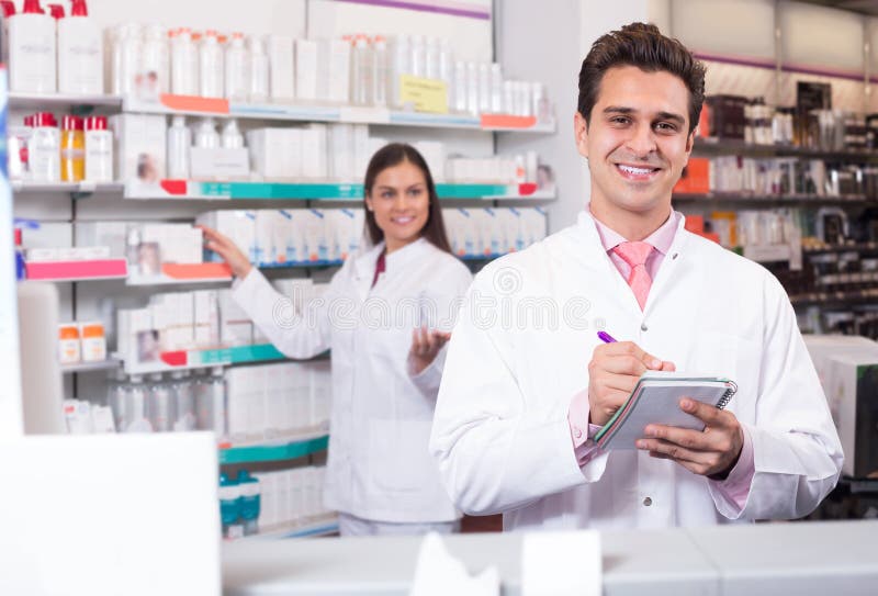 Pharmaceutists at Reception of Drugstore Ready To Help Stock Image ...