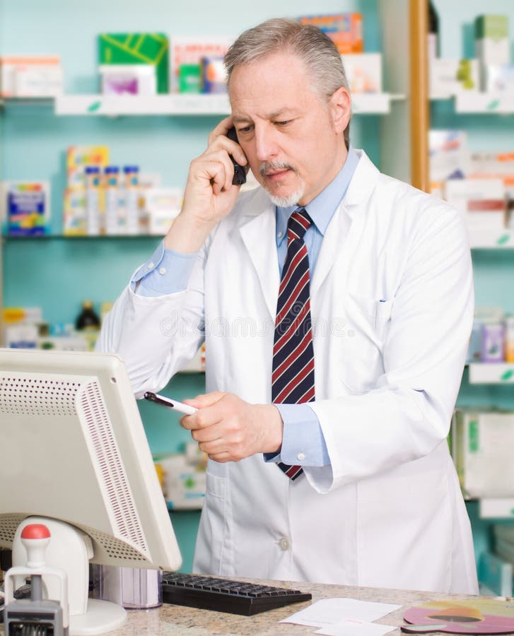 Pharmacist Conversing on Headset in Pharmacy Stock Image - Image of ...