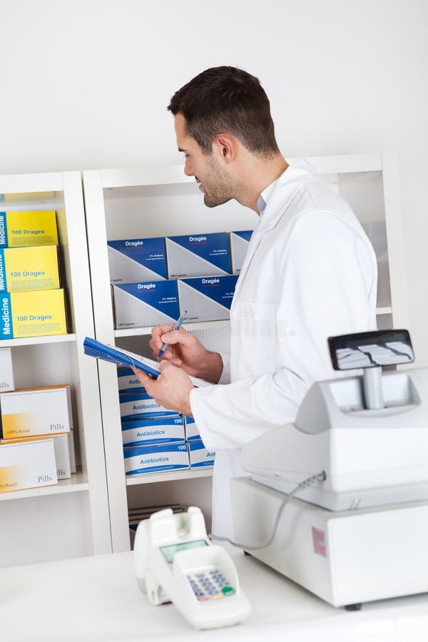 Pharmacist checking drugs stock photo. Image of drugstore - 24151138