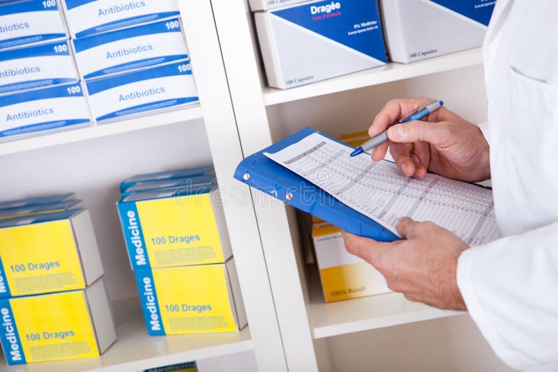 Pharmacist checking drugs stock photo. Image of happy - 52427032