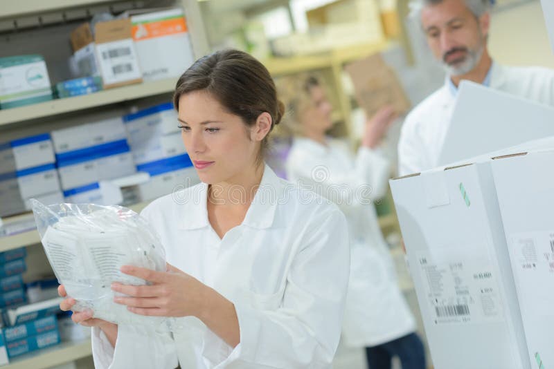 Pharmacist Checking Medicine in Pharmacy Stock Photo - Image of holding ...