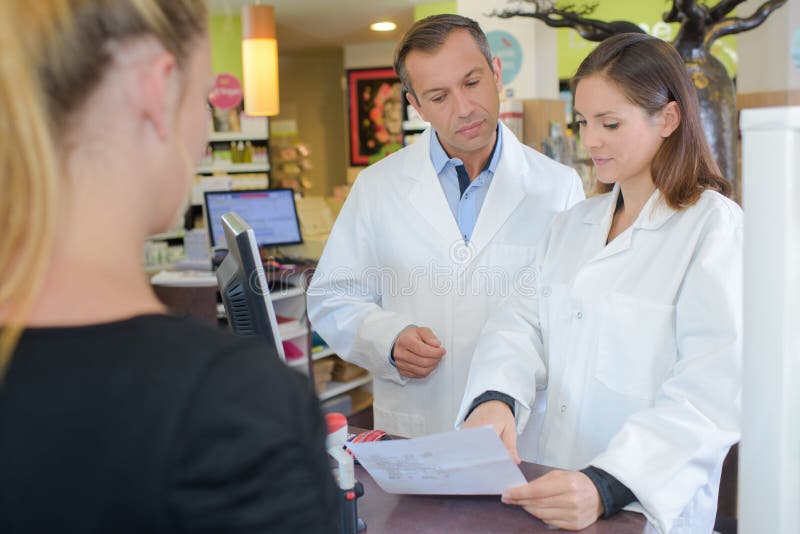 Pharmacist Checking Prescription Stock Image - Image of team, pharmacy ...