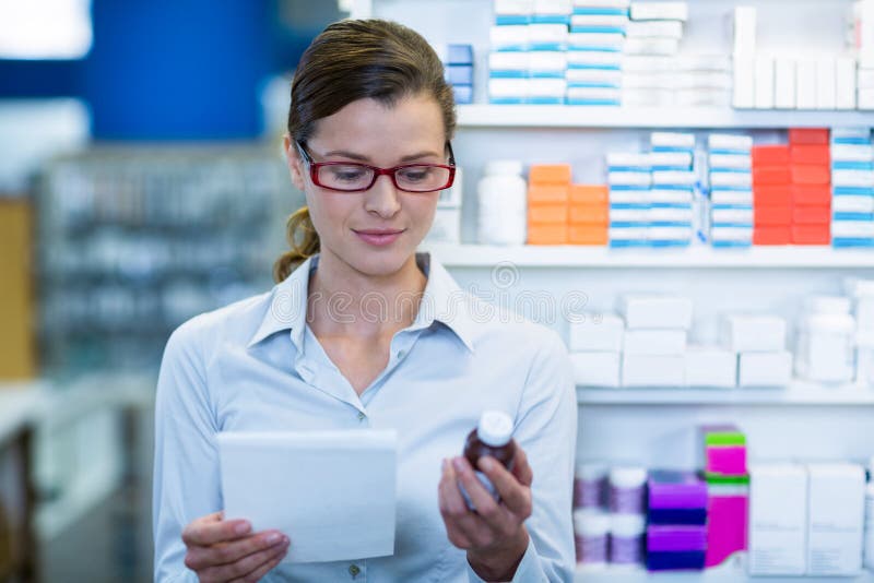Pharmacist Checking at Prescription and Medicine Container Stock Photo ...