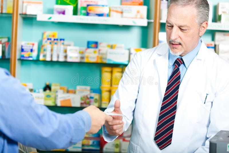 Pharmacist and customer stock photo. Image of customer - 26611500