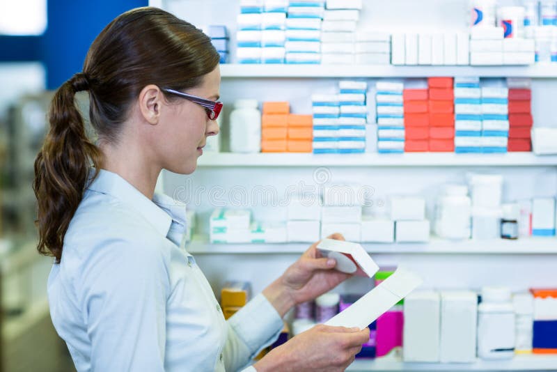 Pharmacist Holding Prescription while Checking Medicine Stock Photo ...