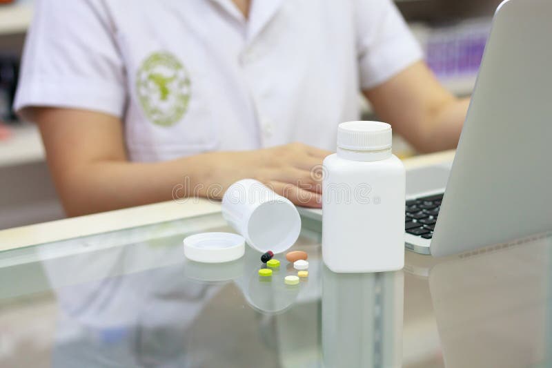 Pharmacist with Laptop Computer and Medication Stock Photo - Image of ...