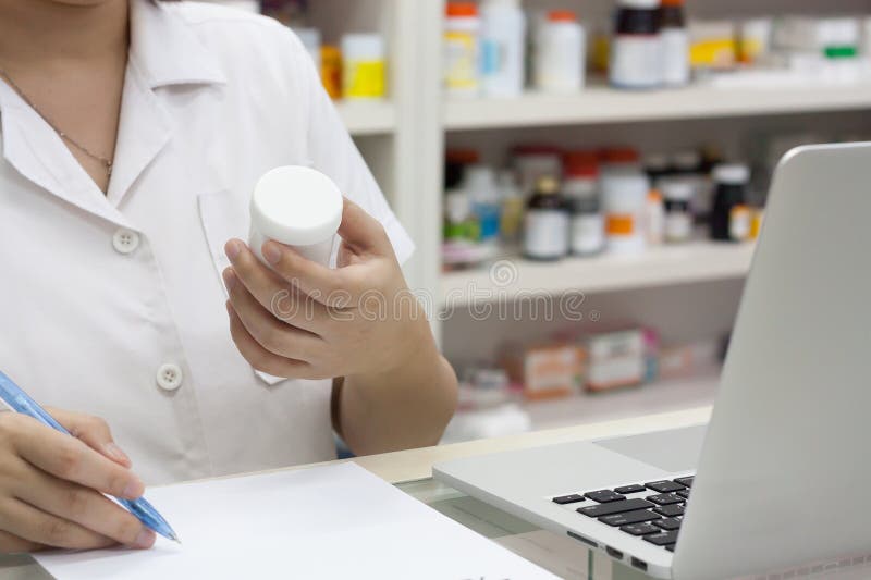 Pharmacist with Laptop Computer and Medication Stock Photo - Image of ...