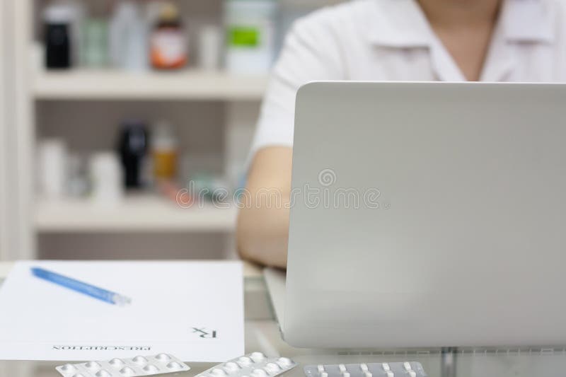 Pharmacist with Laptop Computer and Medication in the Pharmacy Stock ...