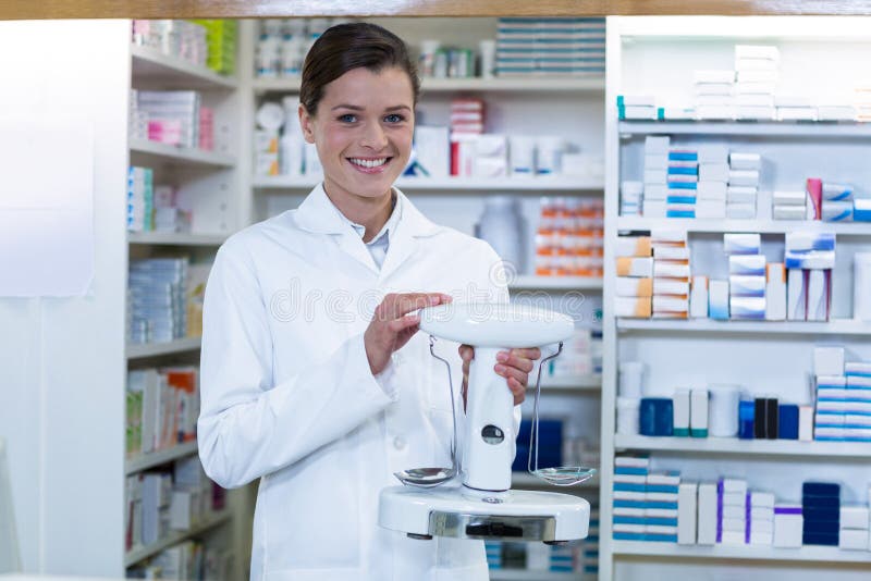 Pharmacist Measuring Tablets with Pharmacy Scale in Pharmacy Stock ...