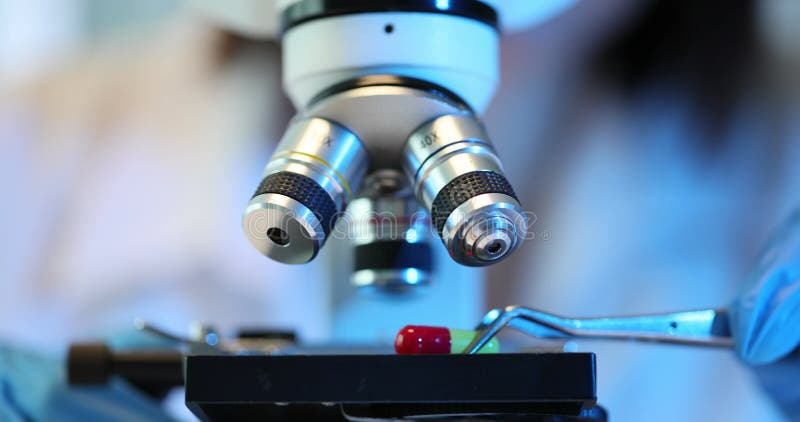Pharmacist Places Medication Capsule Under Microscope Stock Footage ...