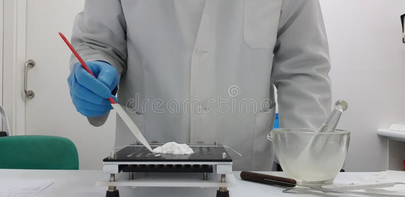 Pharmacist Preparing a Medicine in Capsules Using a Capsule Making ...