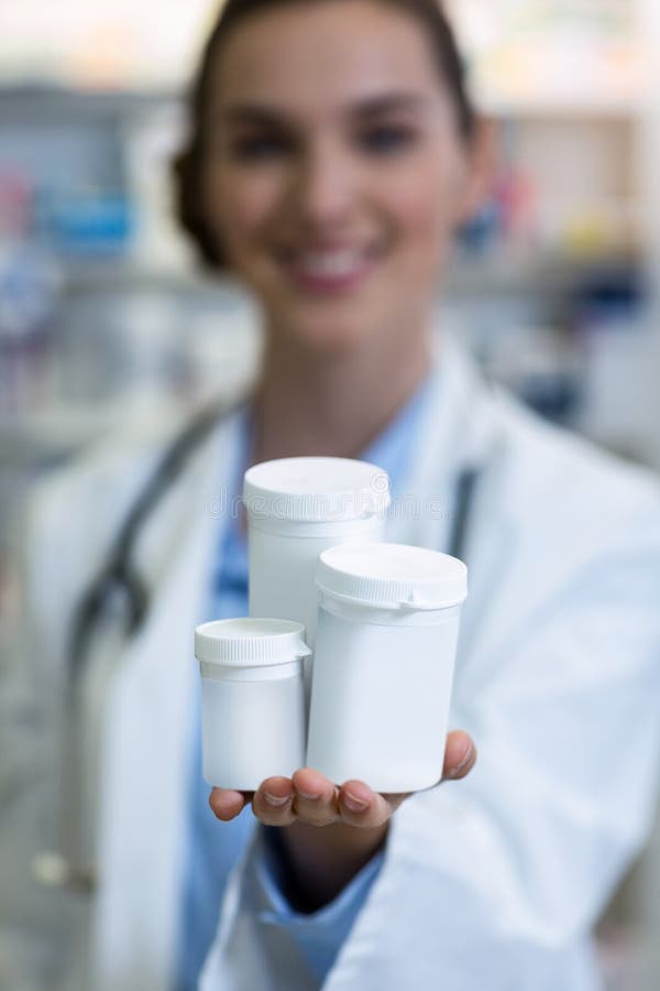 Pharmacist Showing Medicine Container in Pharmacy Stock Image - Image ...