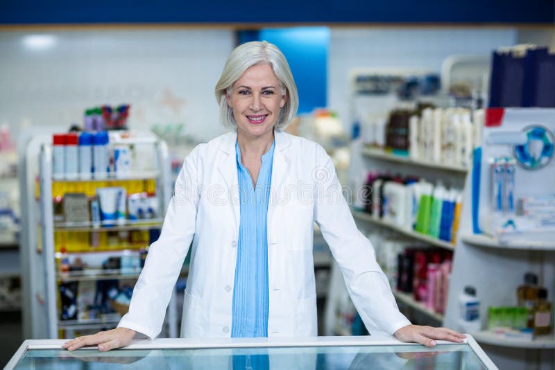 Pharmacist Standing at Counter in Pharmacy Stock Photo - Image of ...
