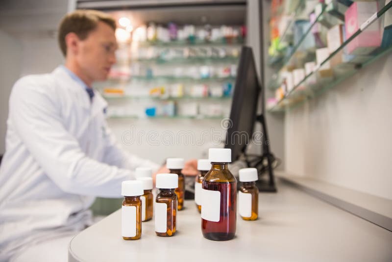 Pharmacist Using Computer at Desk Stock Image - Image of drug, desk ...