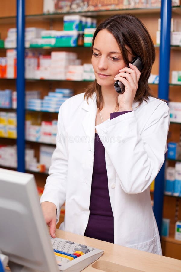 Pharmacist Using Cordless Phone at Desk Stock Image - Image of medicine ...