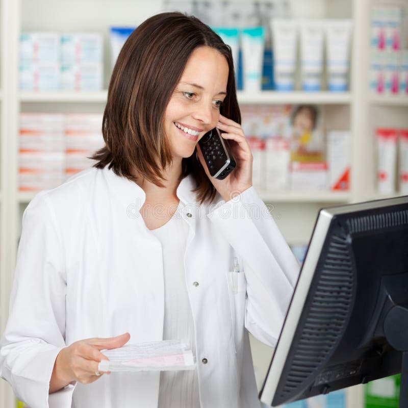 Pharmacist Conversing on Headset in Pharmacy Stock Image - Image of ...